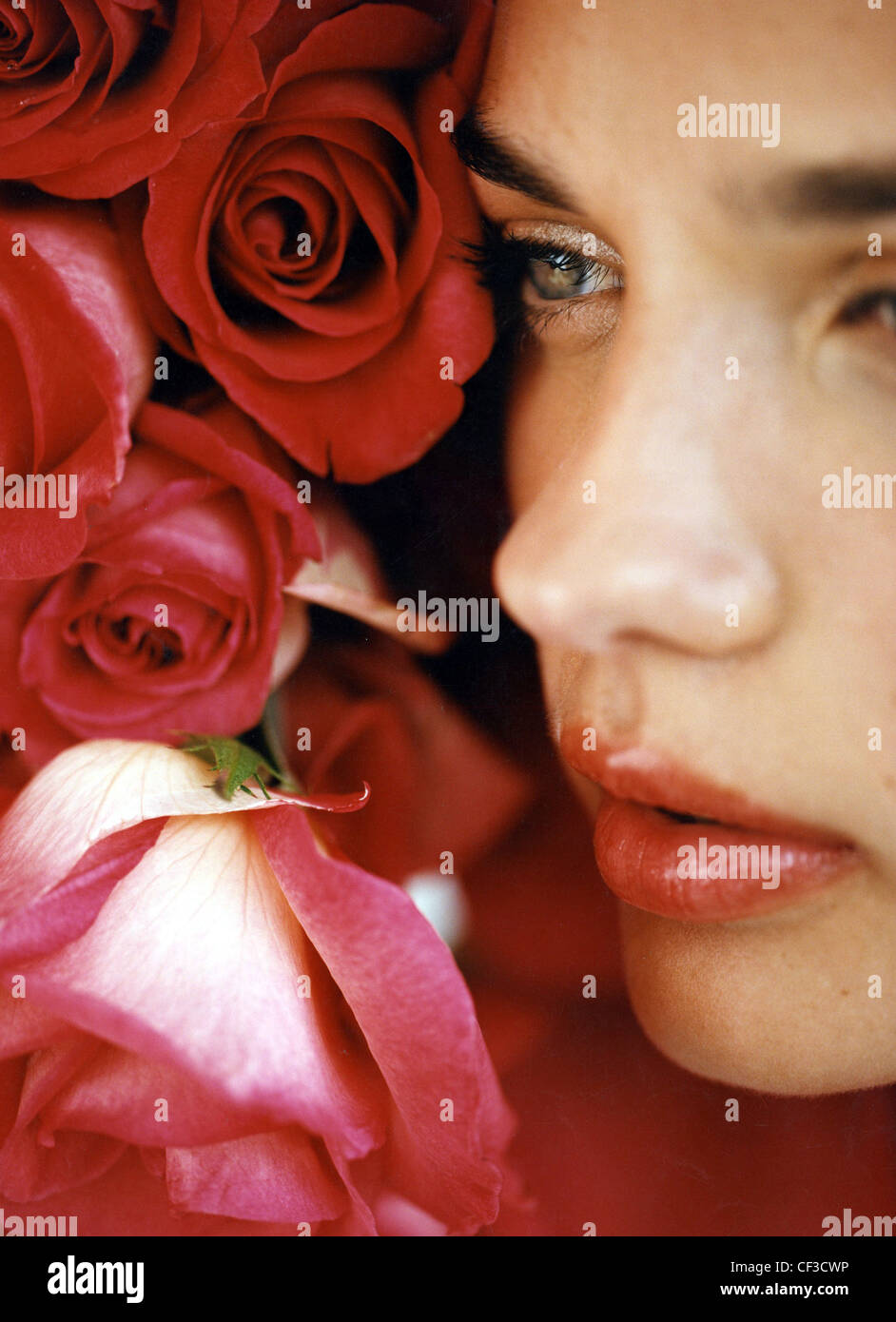 Close up image of female's face with red roses Stock Photo - Alamy