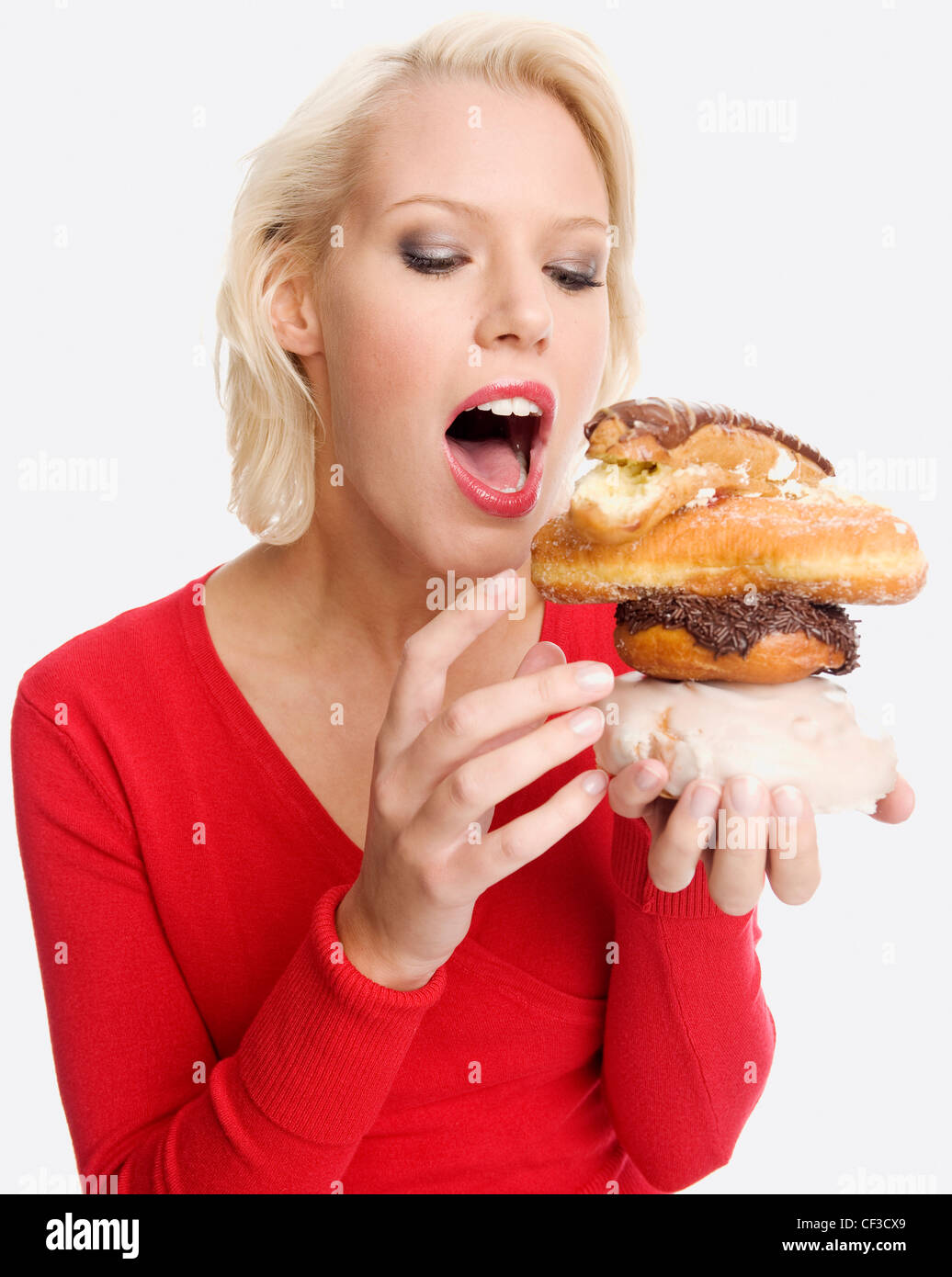 Female Holding An Iced Bun A Chocolate Donut A Sugared Donut And A Chocolate Eclair Piled Up