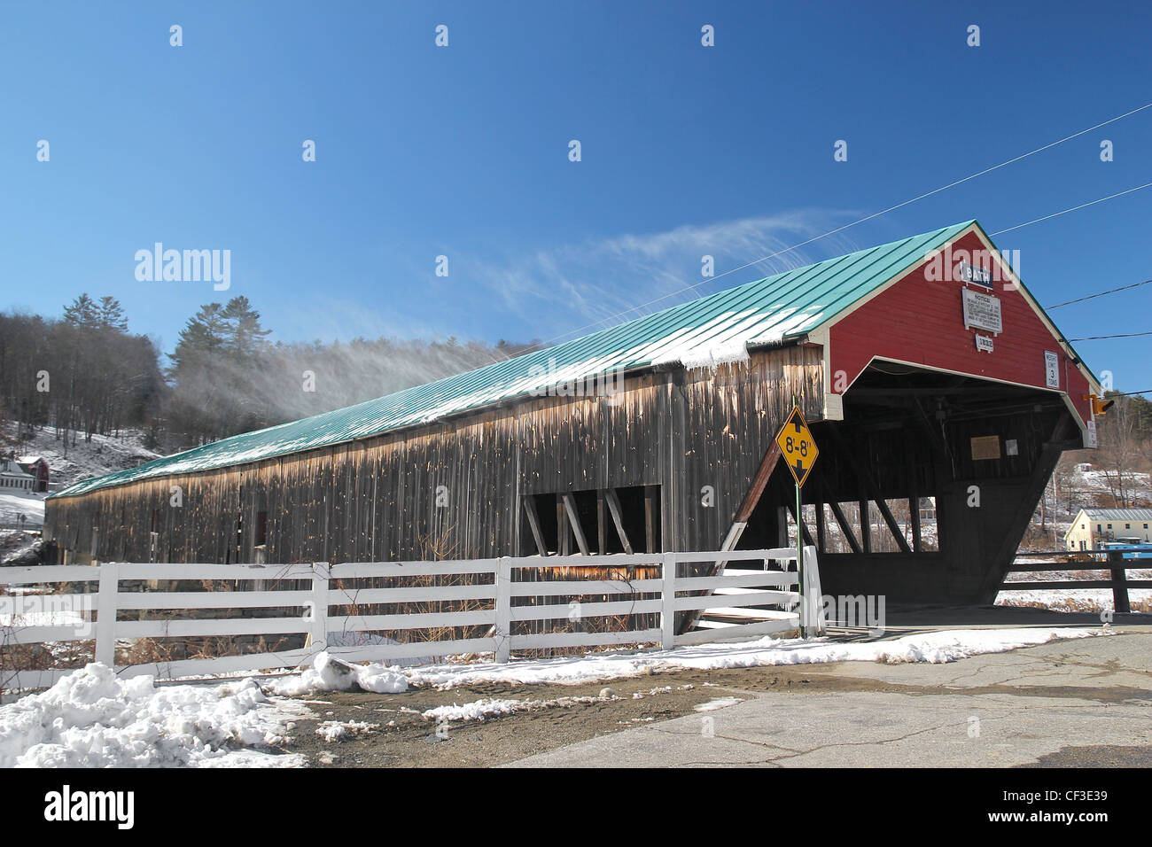 The wind blows snow over a covered bridge Stock Photo - Alamy
