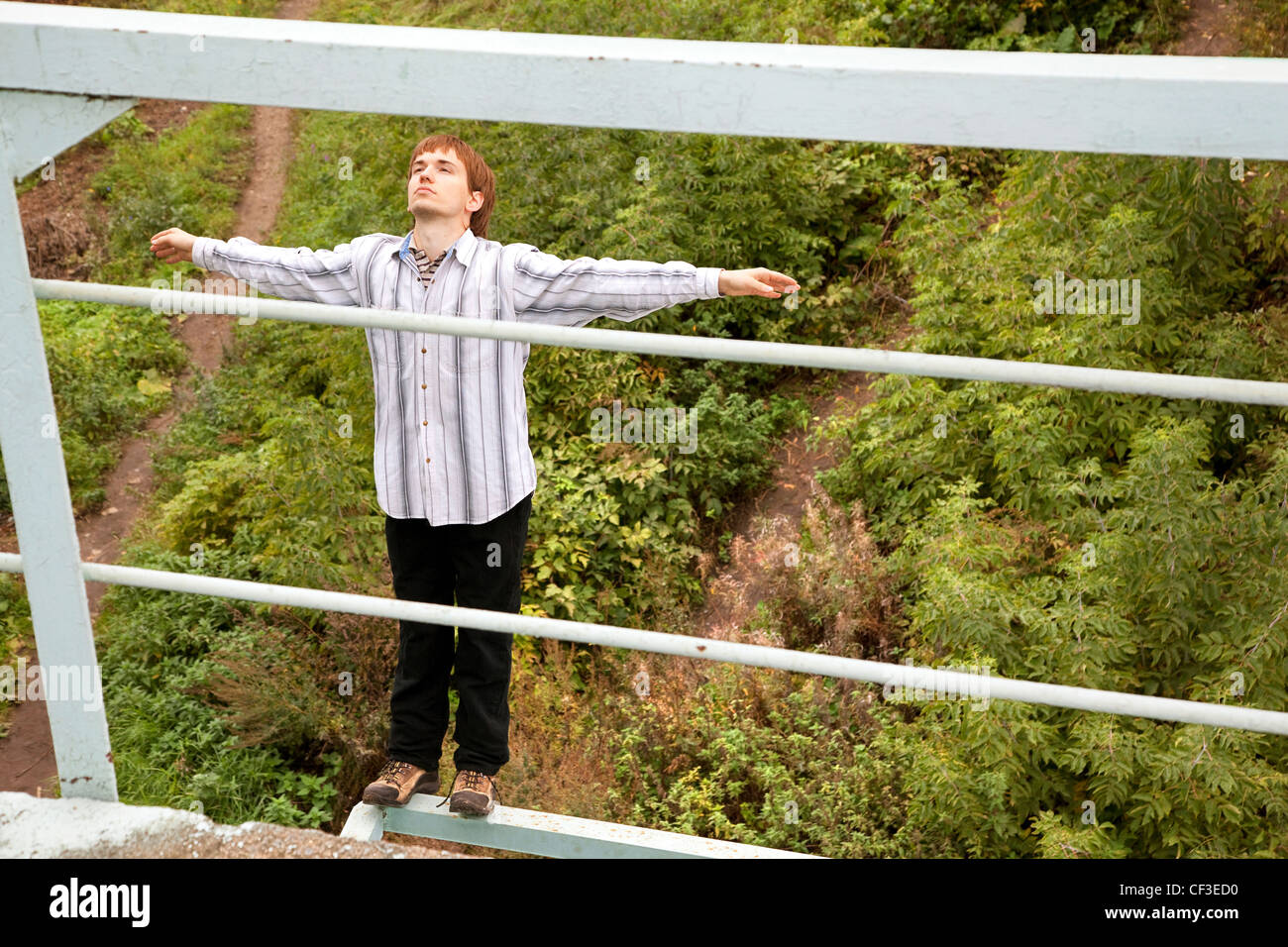 guy is falling from the bridge, view through a handrail Stock Photo - Alamy