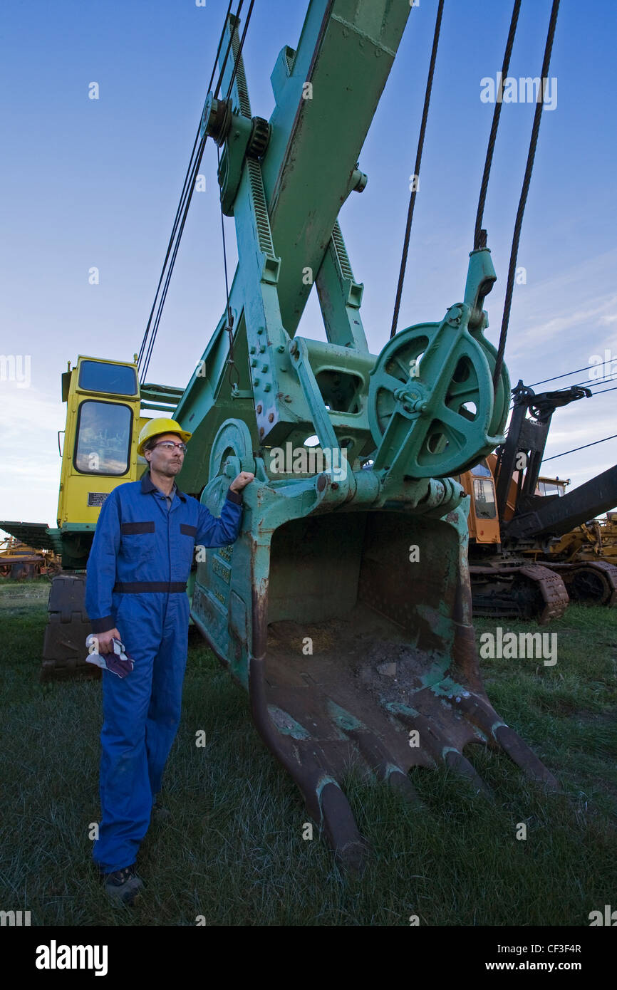 Heavy equipment operator standing next to excavating shovel Stock Photo ...