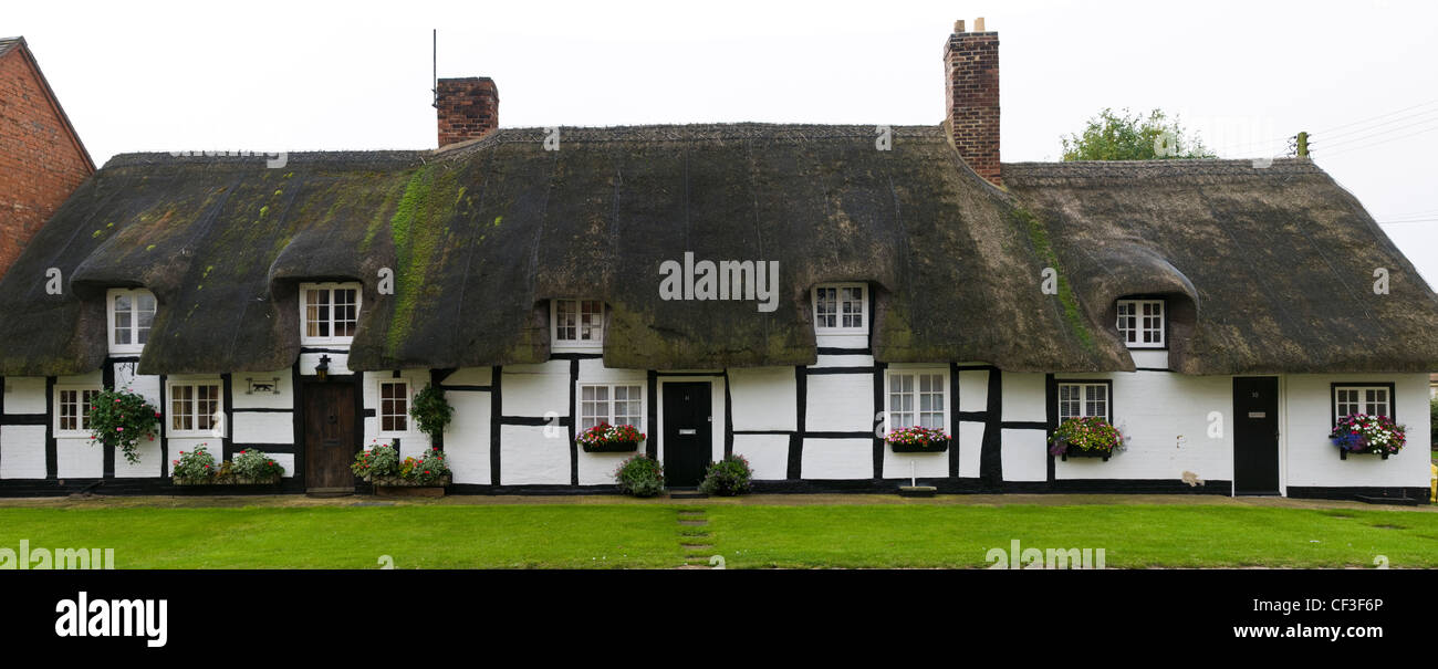 The front of traditional thatched cottages in the village of Lower ...