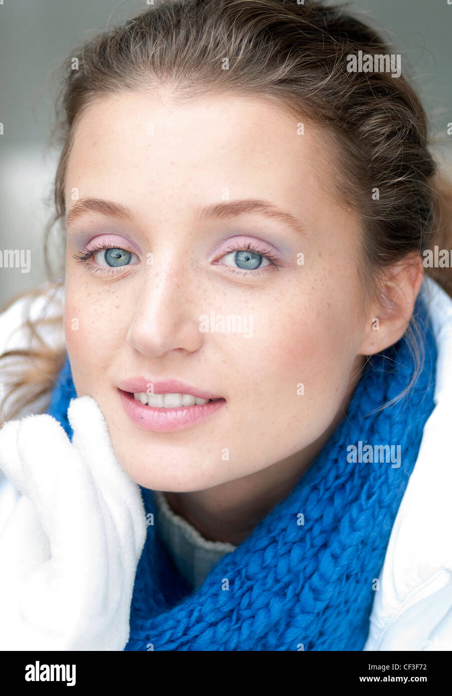 Female with fair hair off her face, wearing a pink eyeshadow and blue ...