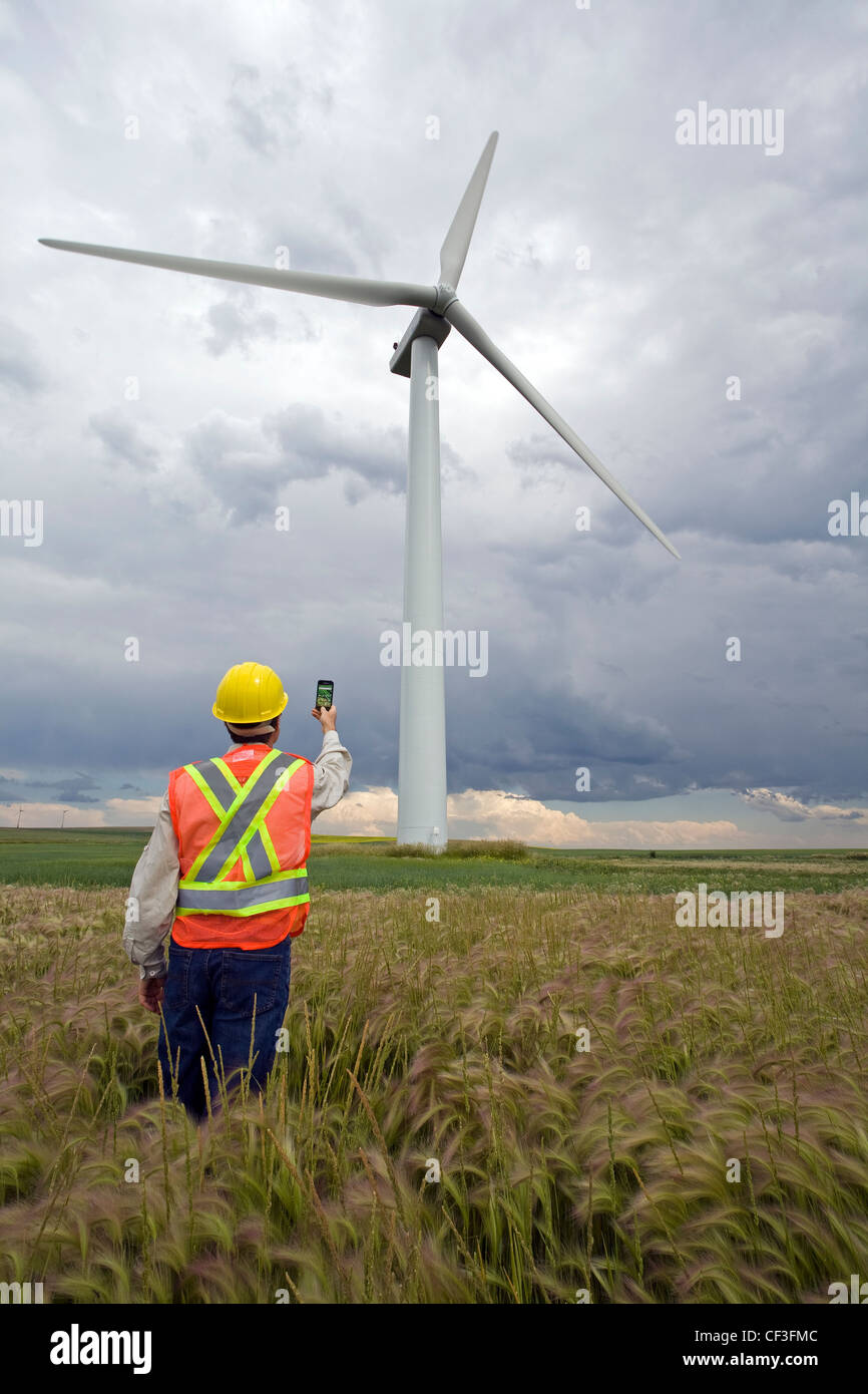 Wind power technician standing next to wind turbine hi-res stock ...