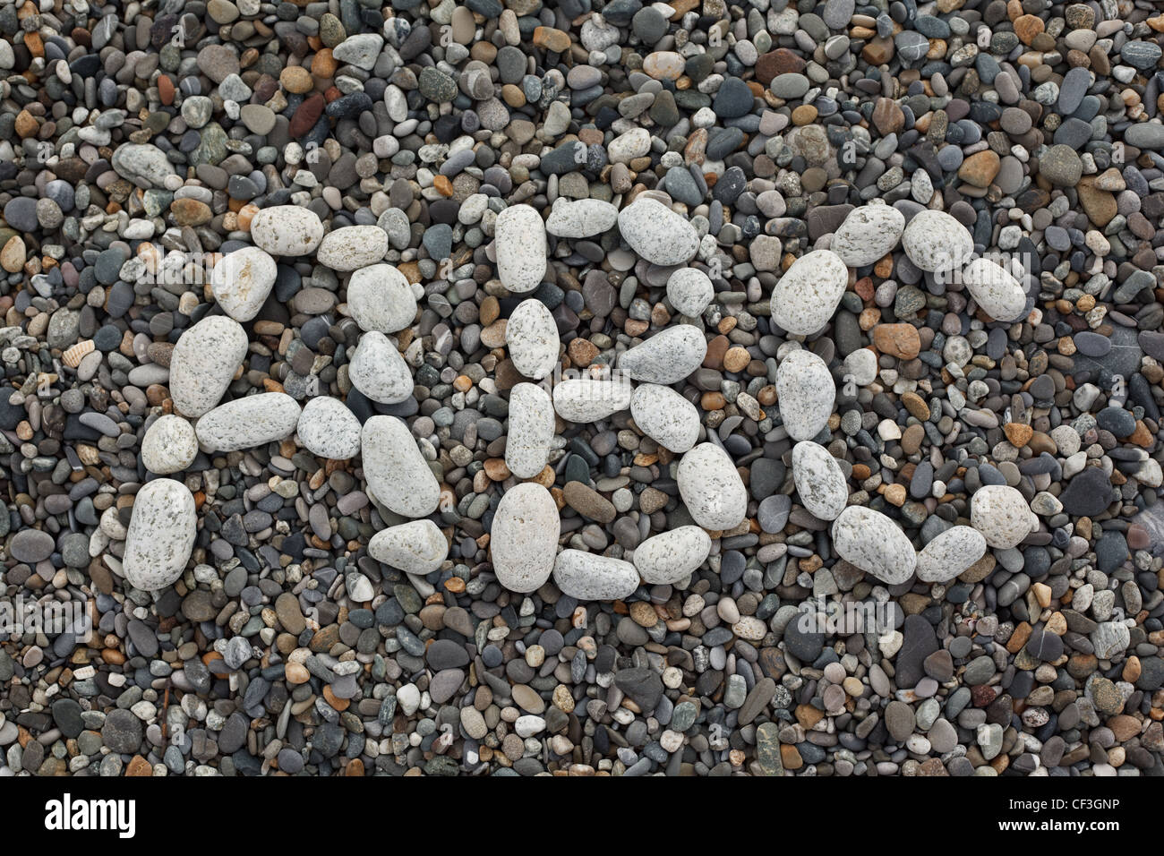 Beach, letters A, B, C combined from white stones, on dark pebble Stock ...