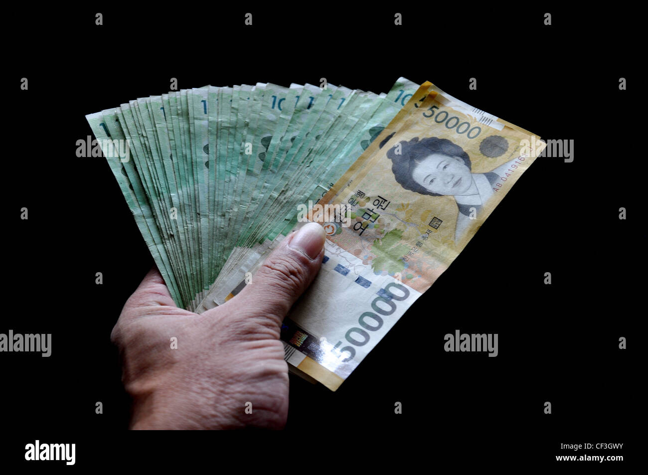 A picture of Hand full of money Stock Photo - Alamy