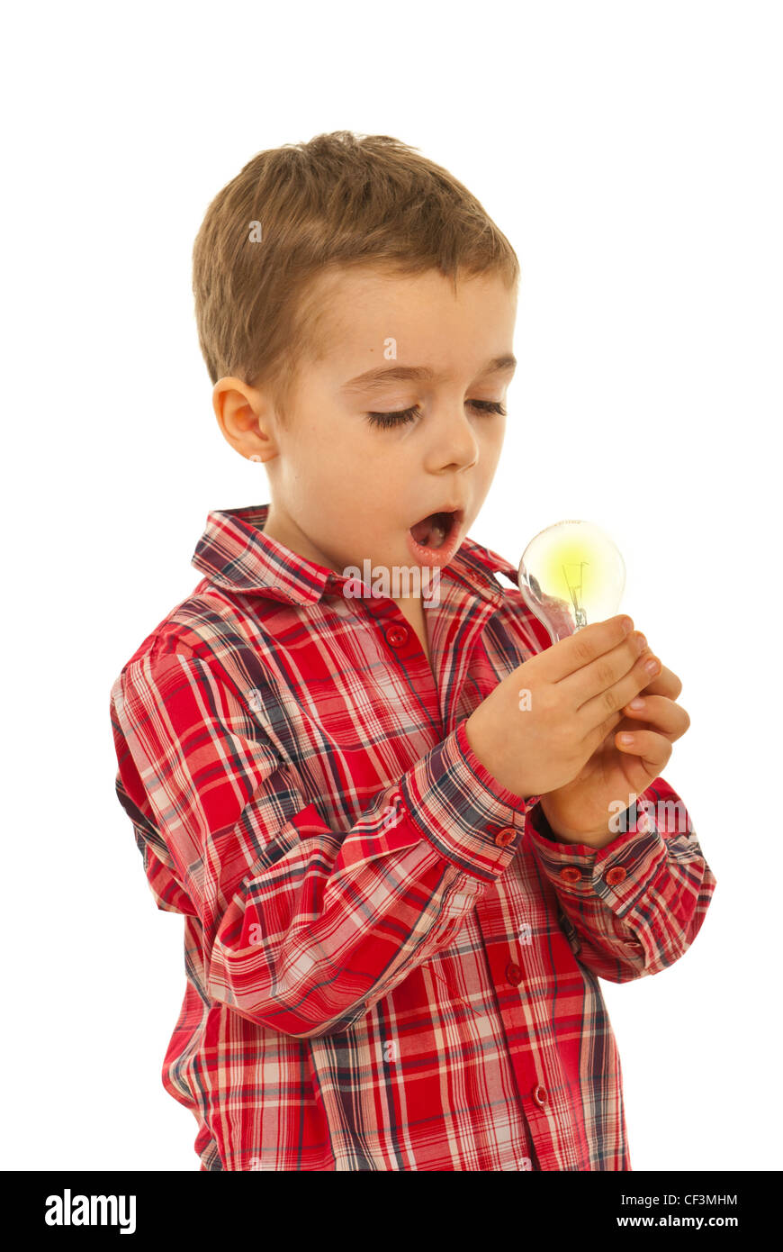 Amazed boy holding light bulb and standing in semi profile isolated on ...