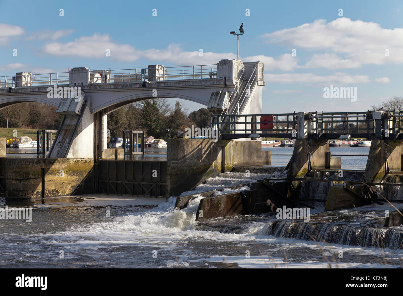 Part of Teddington lock on River Thames near London with weir and ...