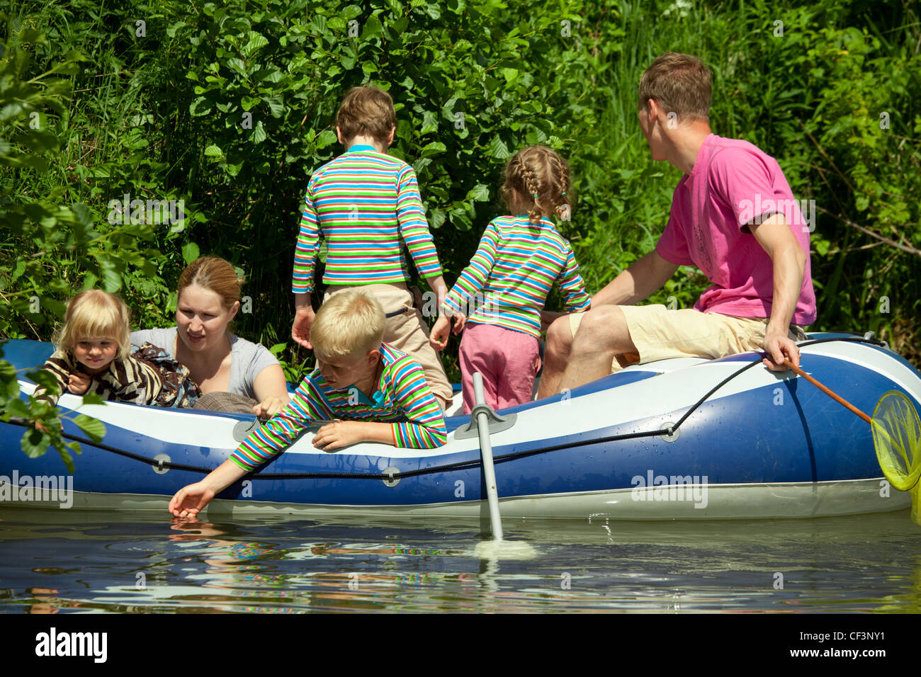 Family with inflatable boat hi-res stock photography and images - Alamy