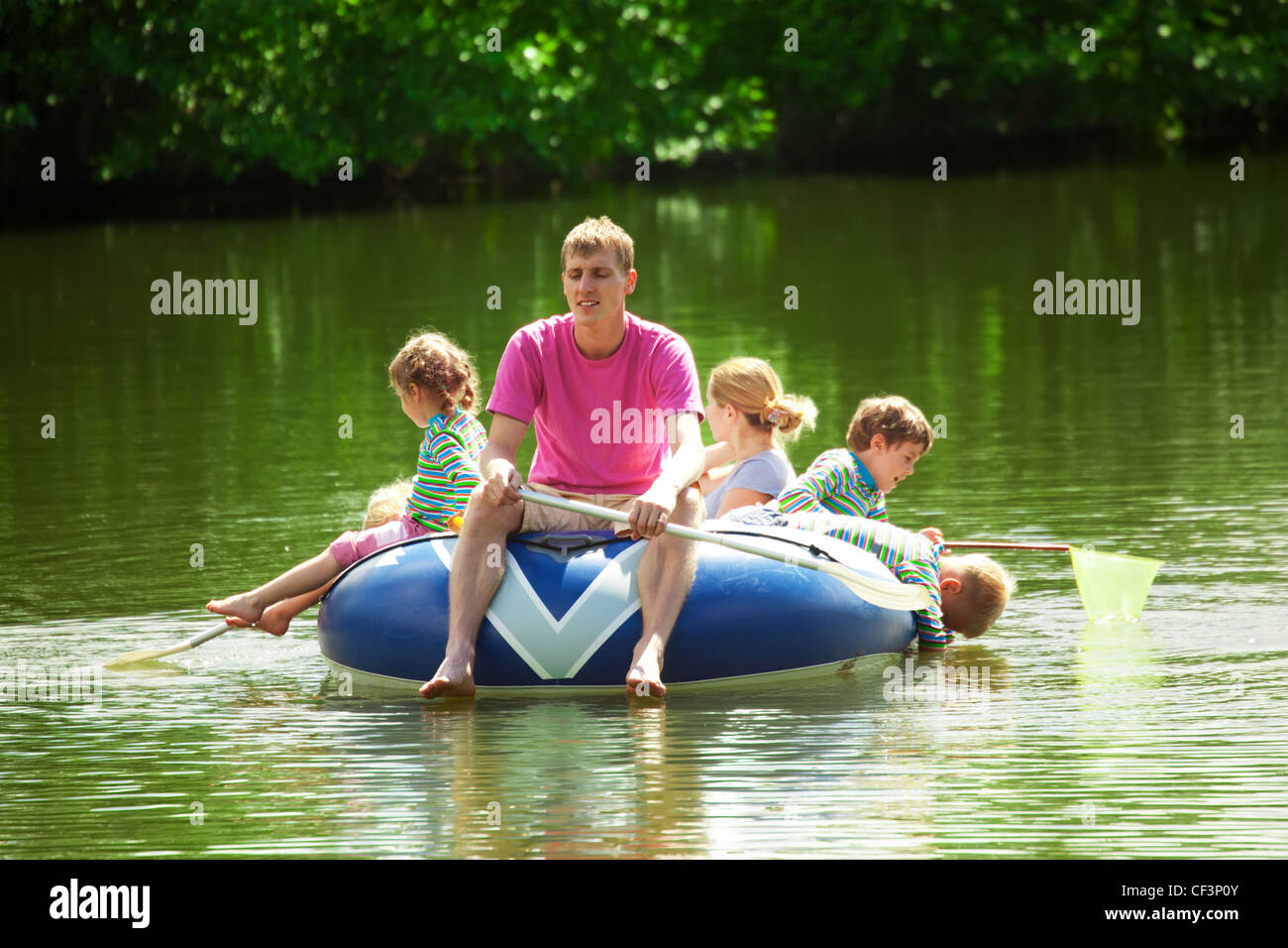 Family with inflatable boat hi-res stock photography and images - Alamy