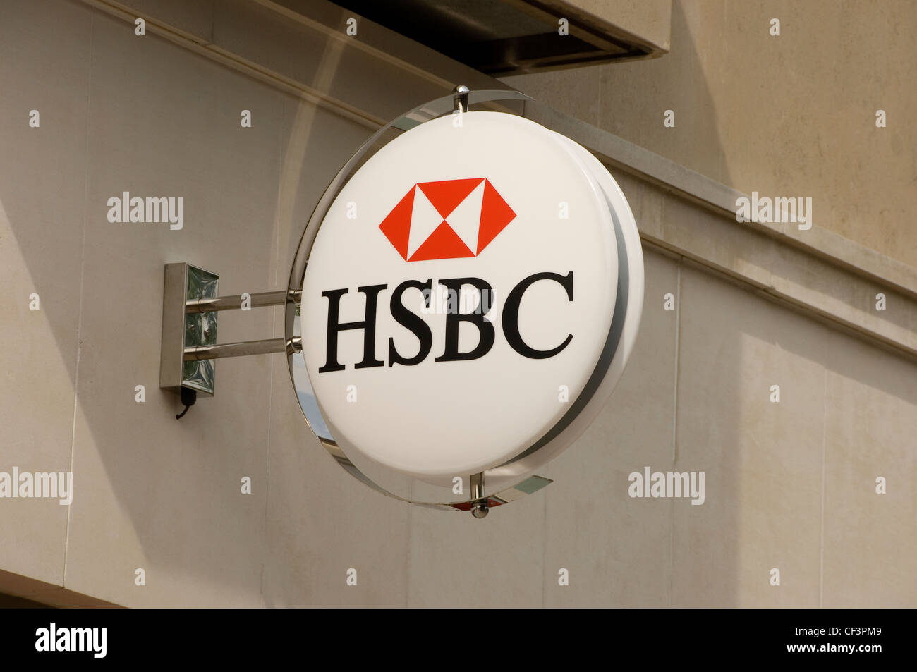 An HSBC bank sign mounted to a wall outside a branch of the bank Stock ...