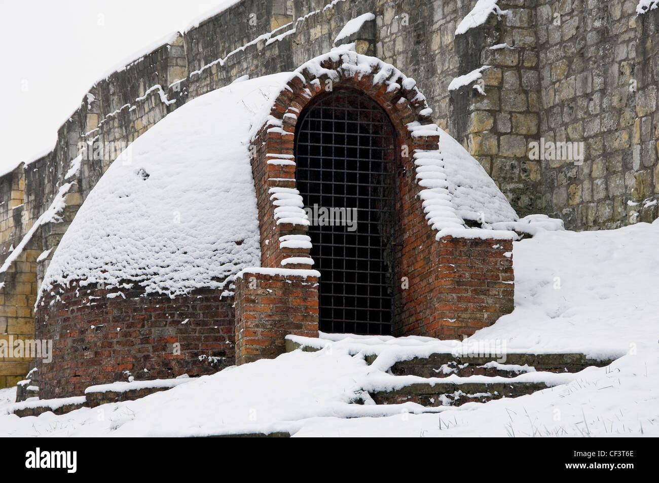 The ice house covered in snow. The igloo-shaped building adjacent to ...