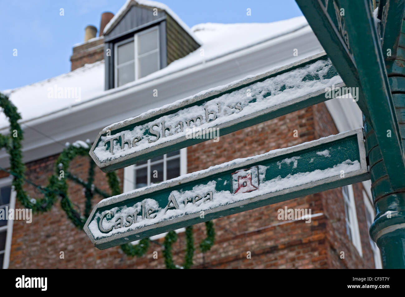 Snow on a tourist information sign with directions to The Shambles and ...