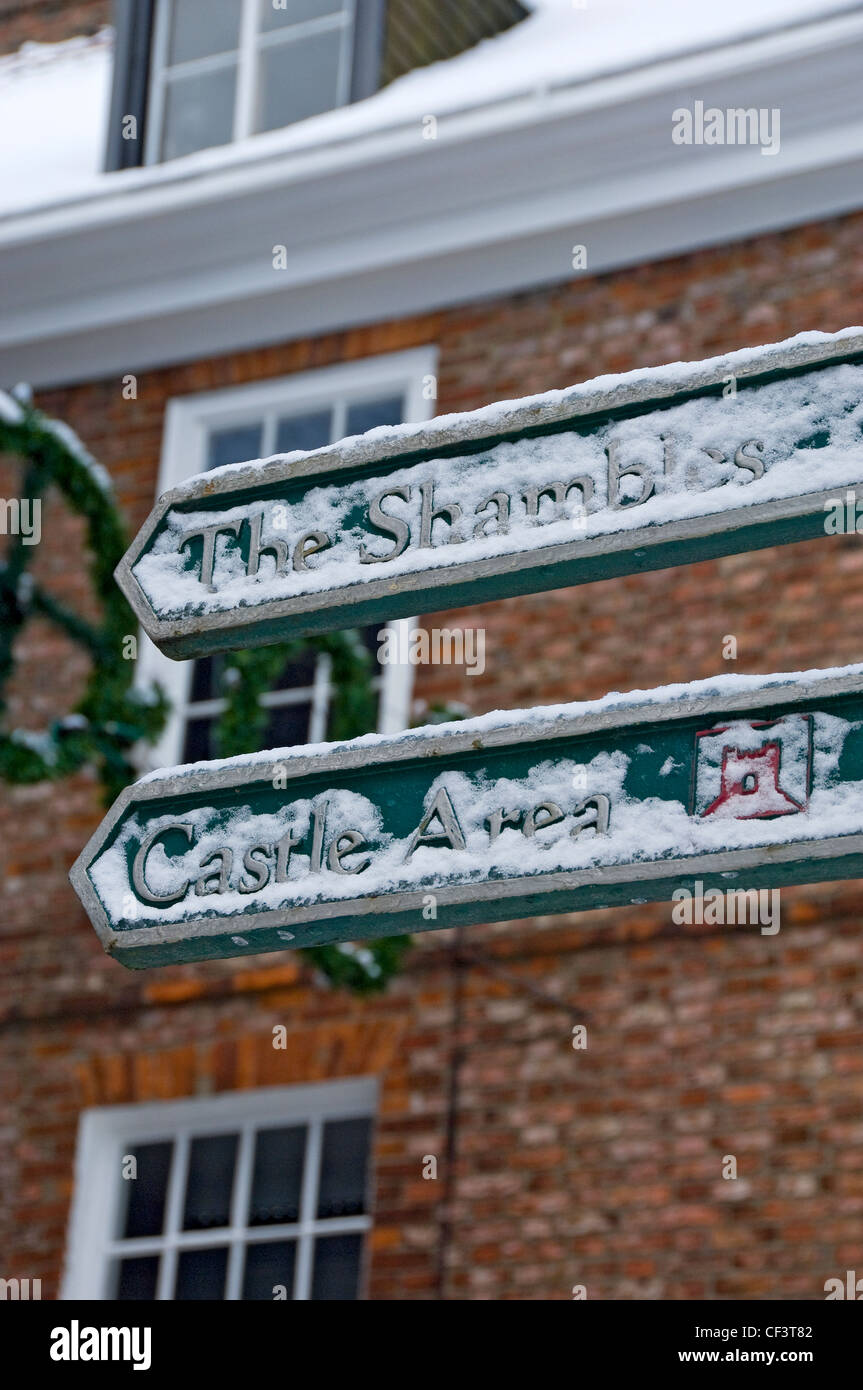 Snow on a tourist information sign with directions to The Shambles and ...