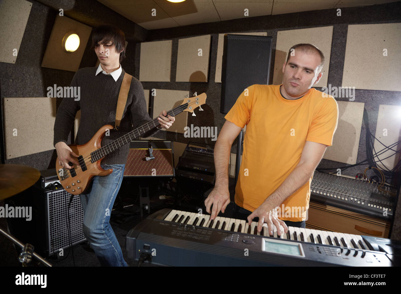 electro guitar player and keyboarder working in studio Stock Photo - Alamy