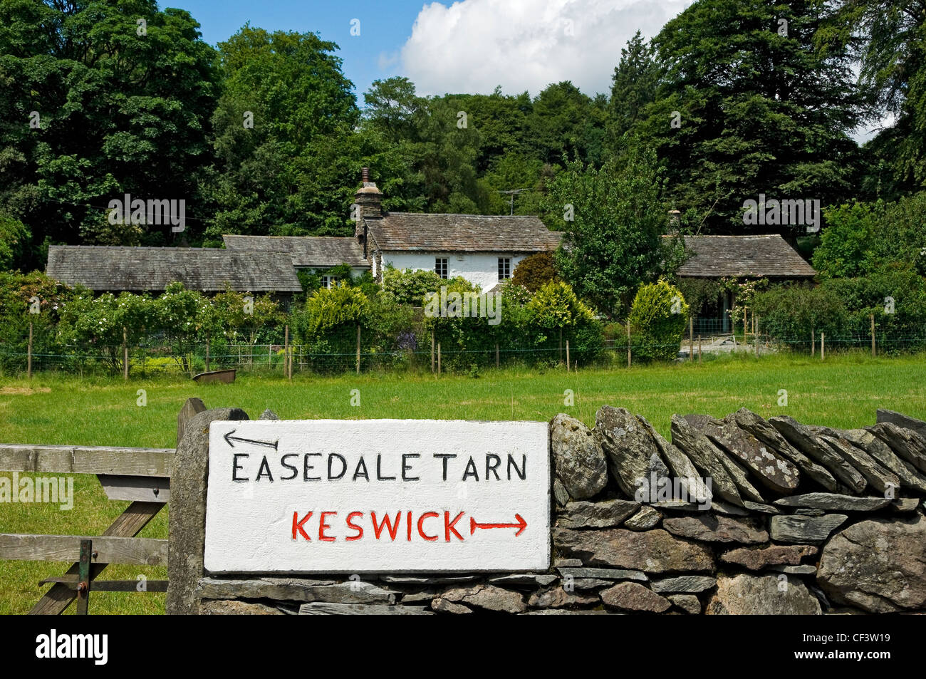 A hand carved sign with directions to Easedale Tarn and Keswick on a ...