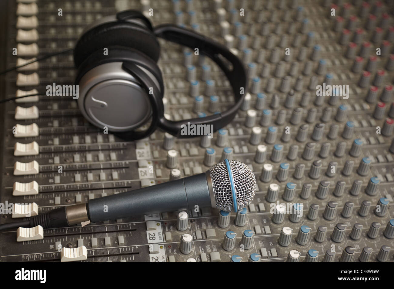 headphones and microphone on old dirty sound mixer pult. microphone in ...