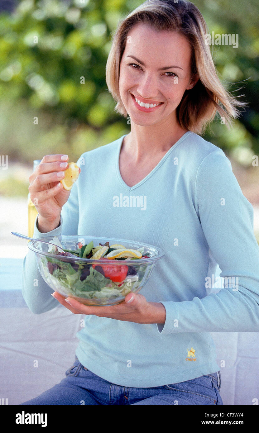 Female Shoulder Length Blonde Hair Wearing Blue Top And Blue Denim