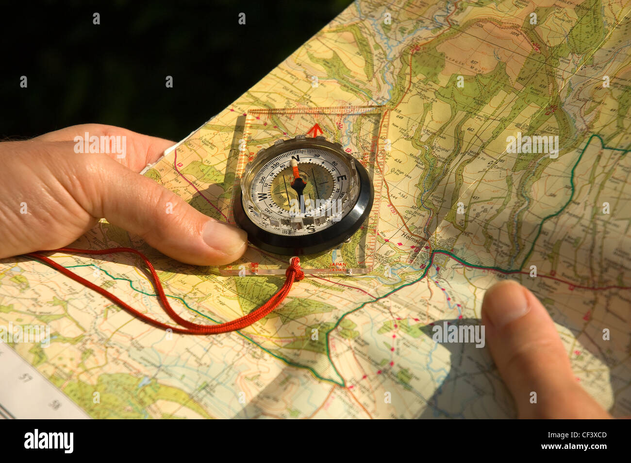A man holding a walking map and compass Stock Photo - Alamy