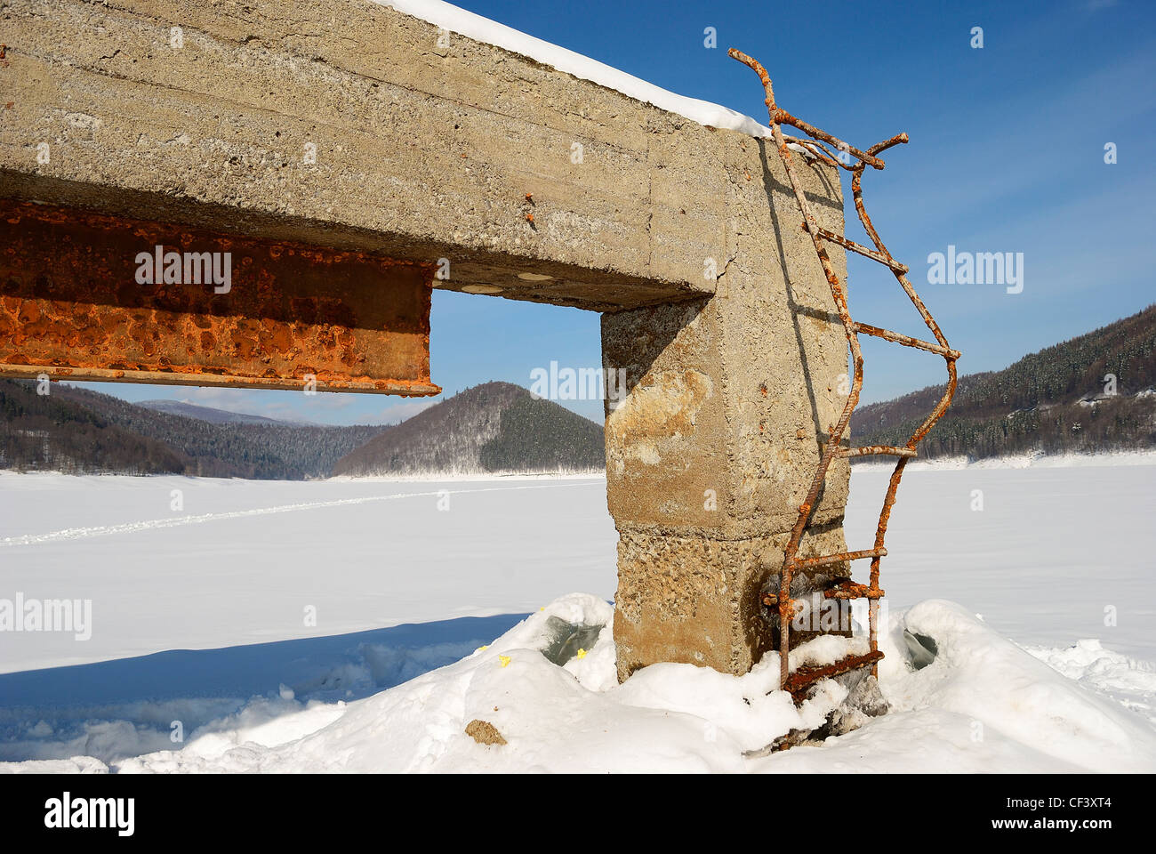Freeze rusty ladder on a concrete pillar Stock Photo - Alamy
