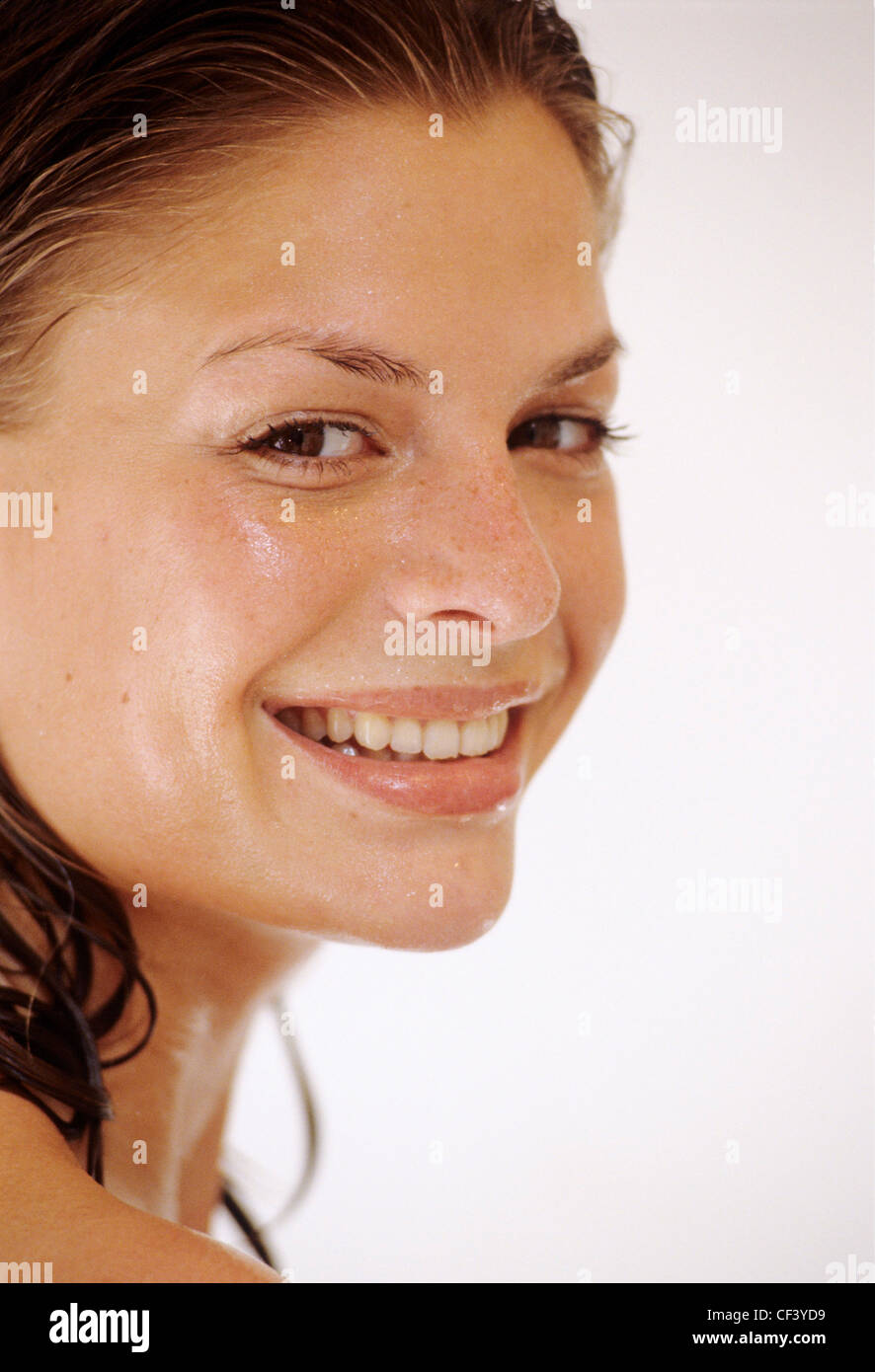 Female with long wet brunette hair, droplets of water on face, looking ...