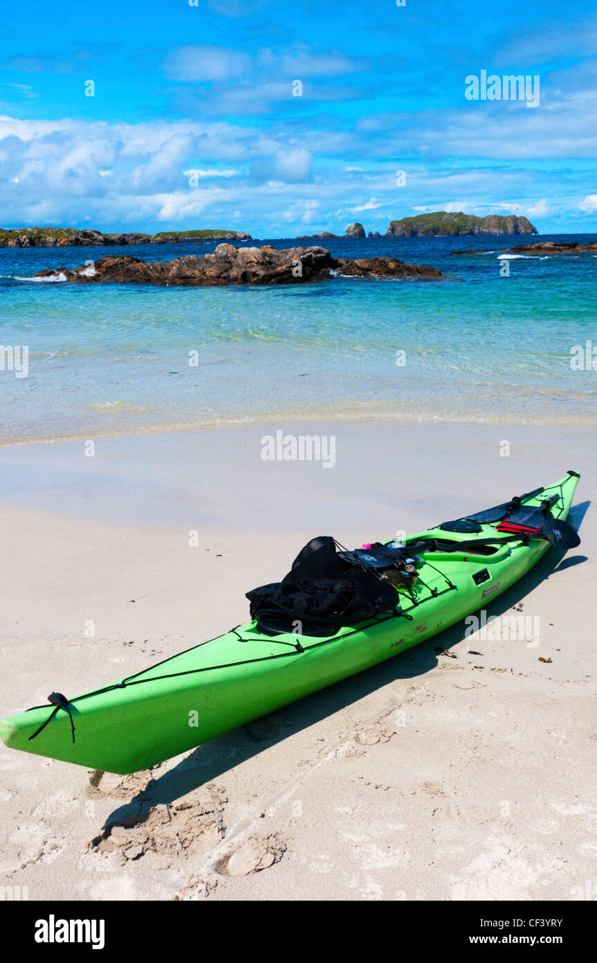 A kayak pulled up on an empty beach on Great Bernera in the Outer ...