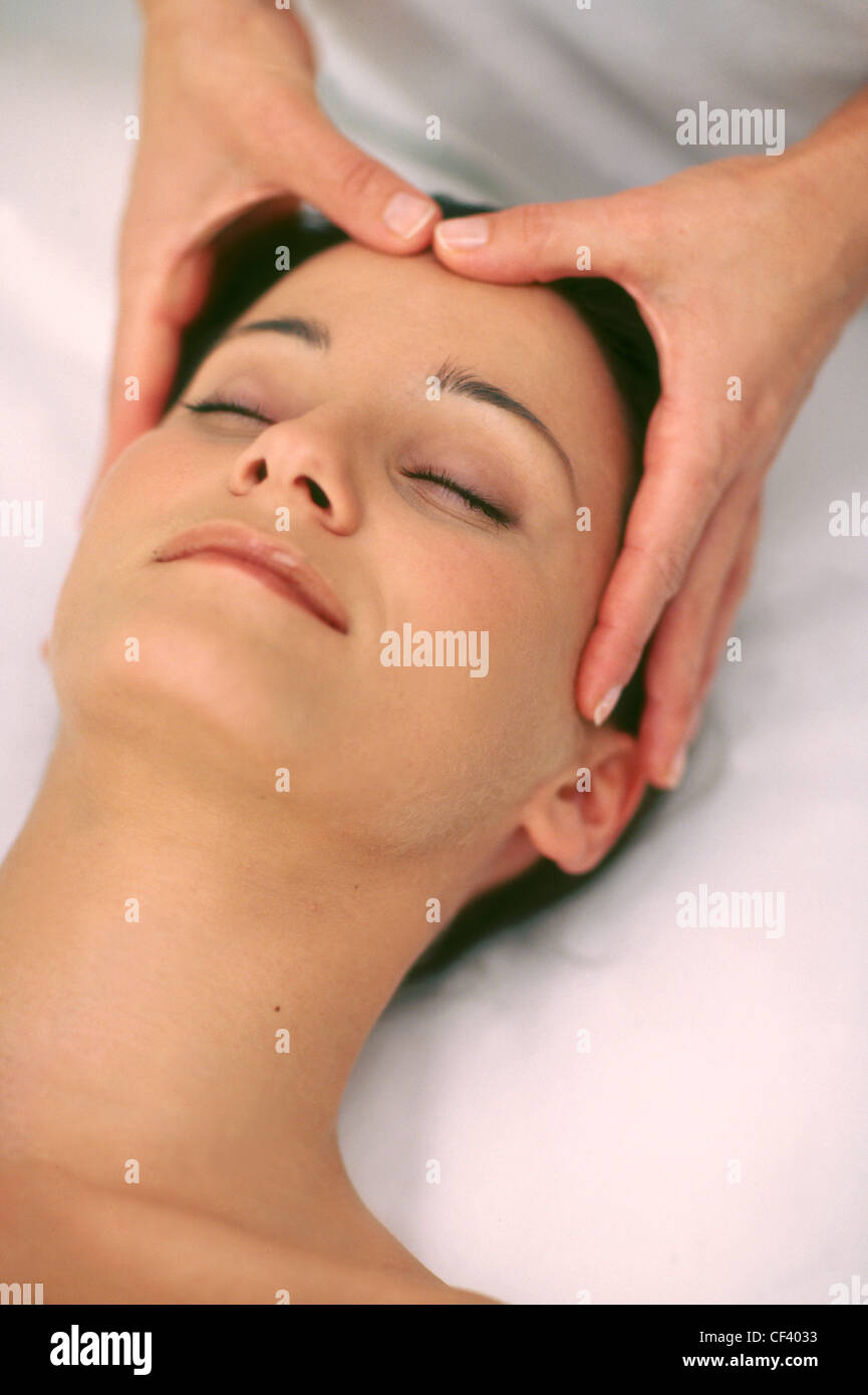 Female with brunette hair off face lying on back eyes closed, female ...