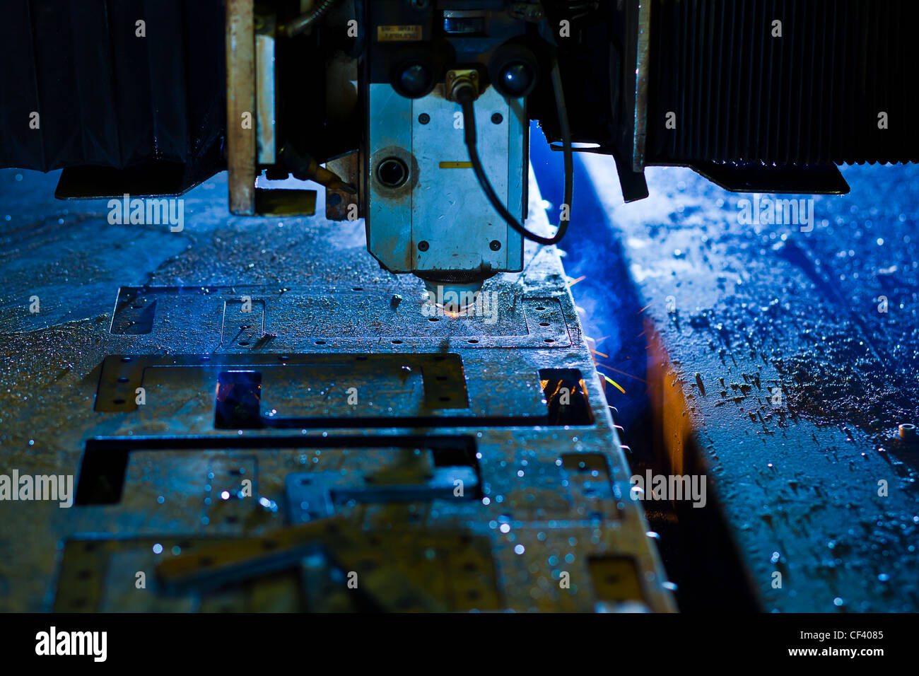 Laser cutting with sparks close up Stock Photo - Alamy