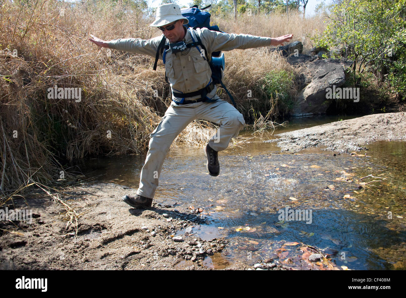 A man jumps over a River in Zimbabwe's Mavuradona National Park Stock ...