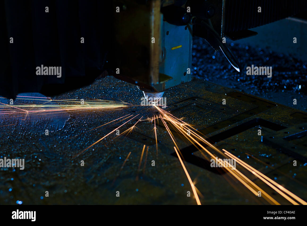 Laser cutting with sparks close up Stock Photo - Alamy