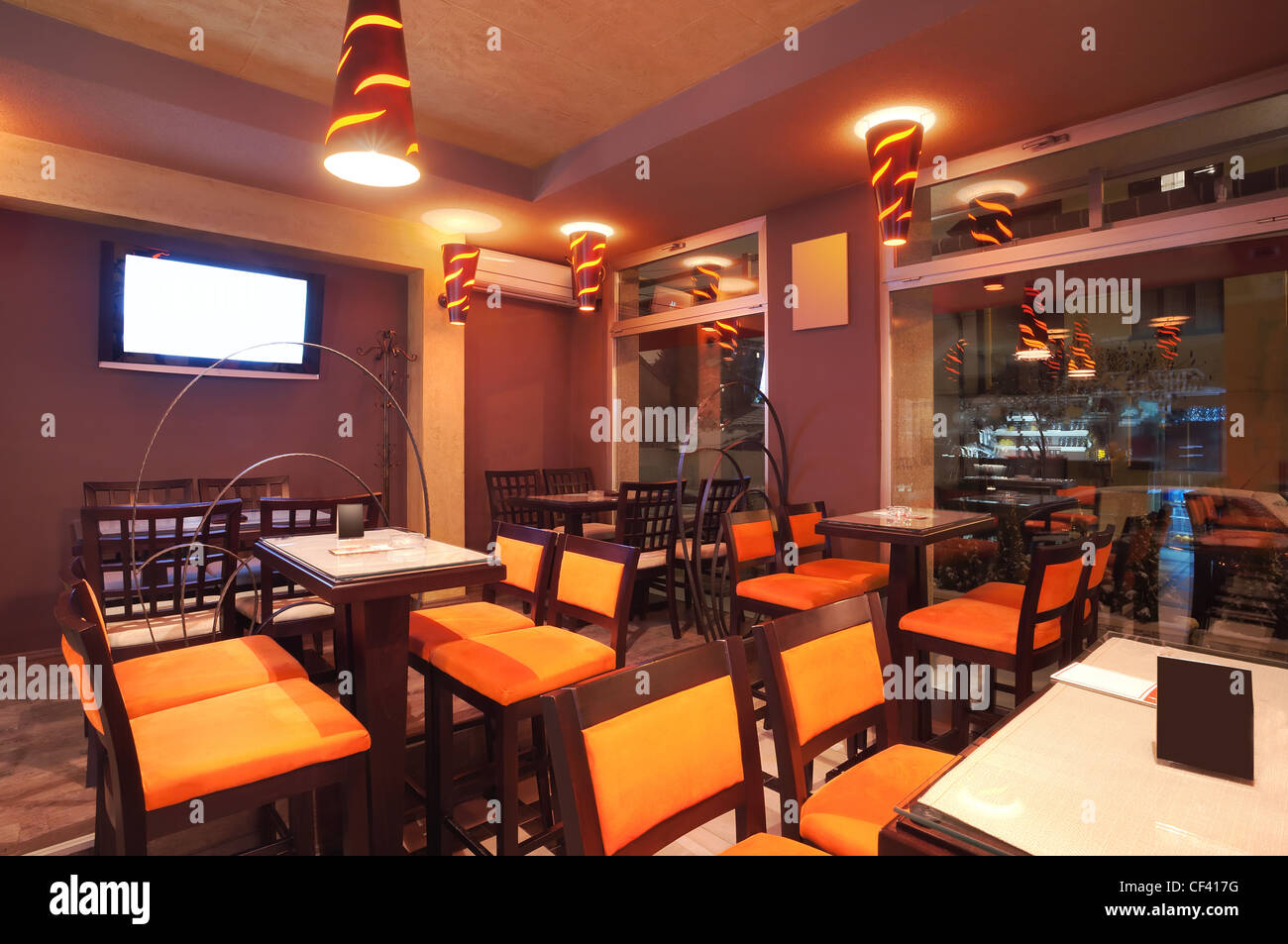 Interior of a restaurant, modern design in few colors, orange and brown ...