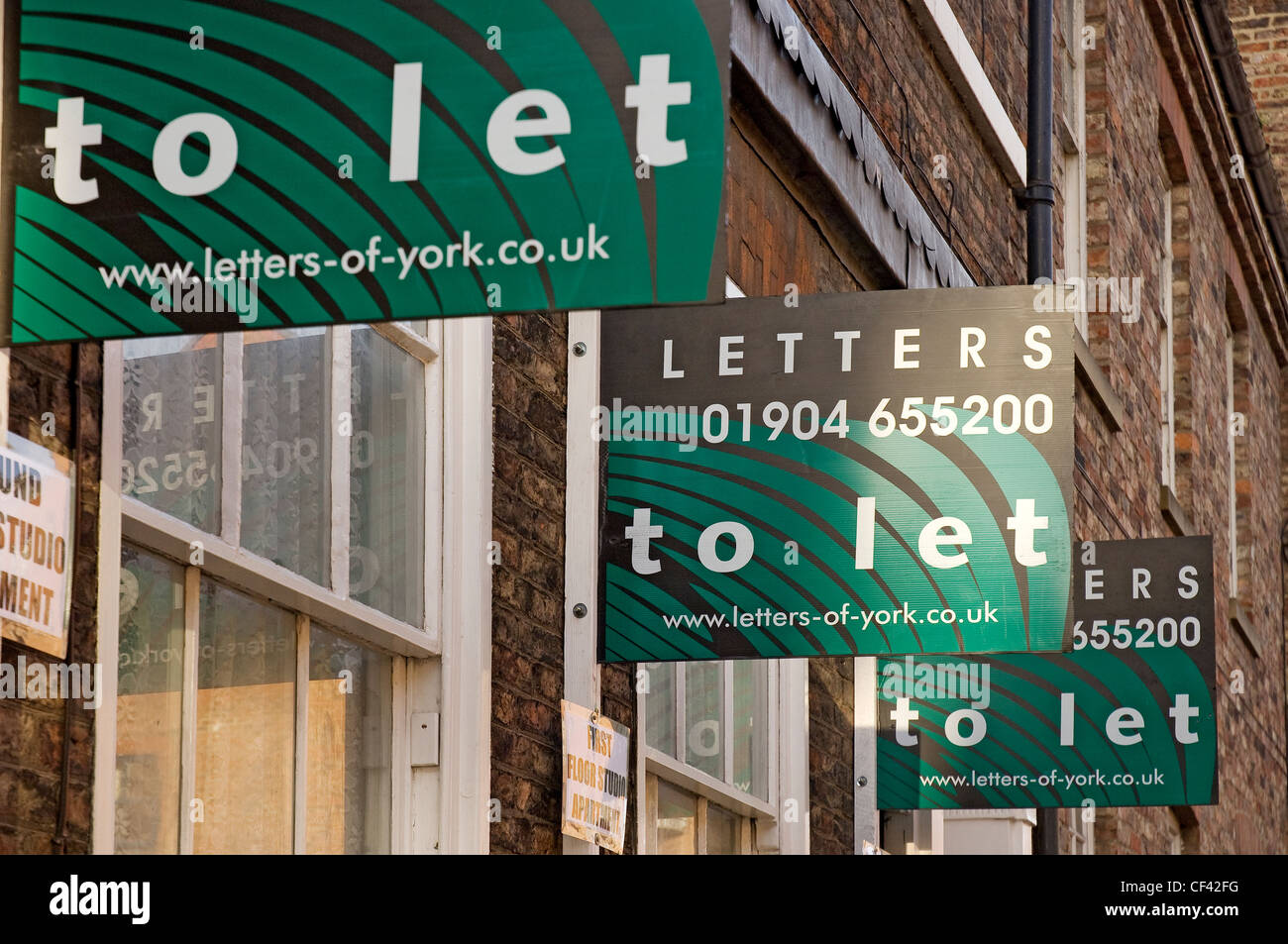 Three to let property sign boards outside houses in York Stock Photo ...