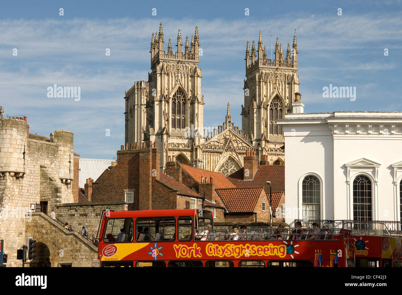 A red sightseeing bus and Bootham Bar Exhibition Square with York ...