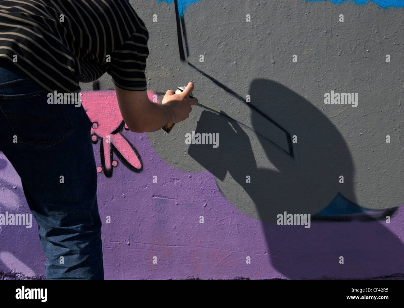 Graffiti writer and shadow. The word 'graffiti' is the plural of ...