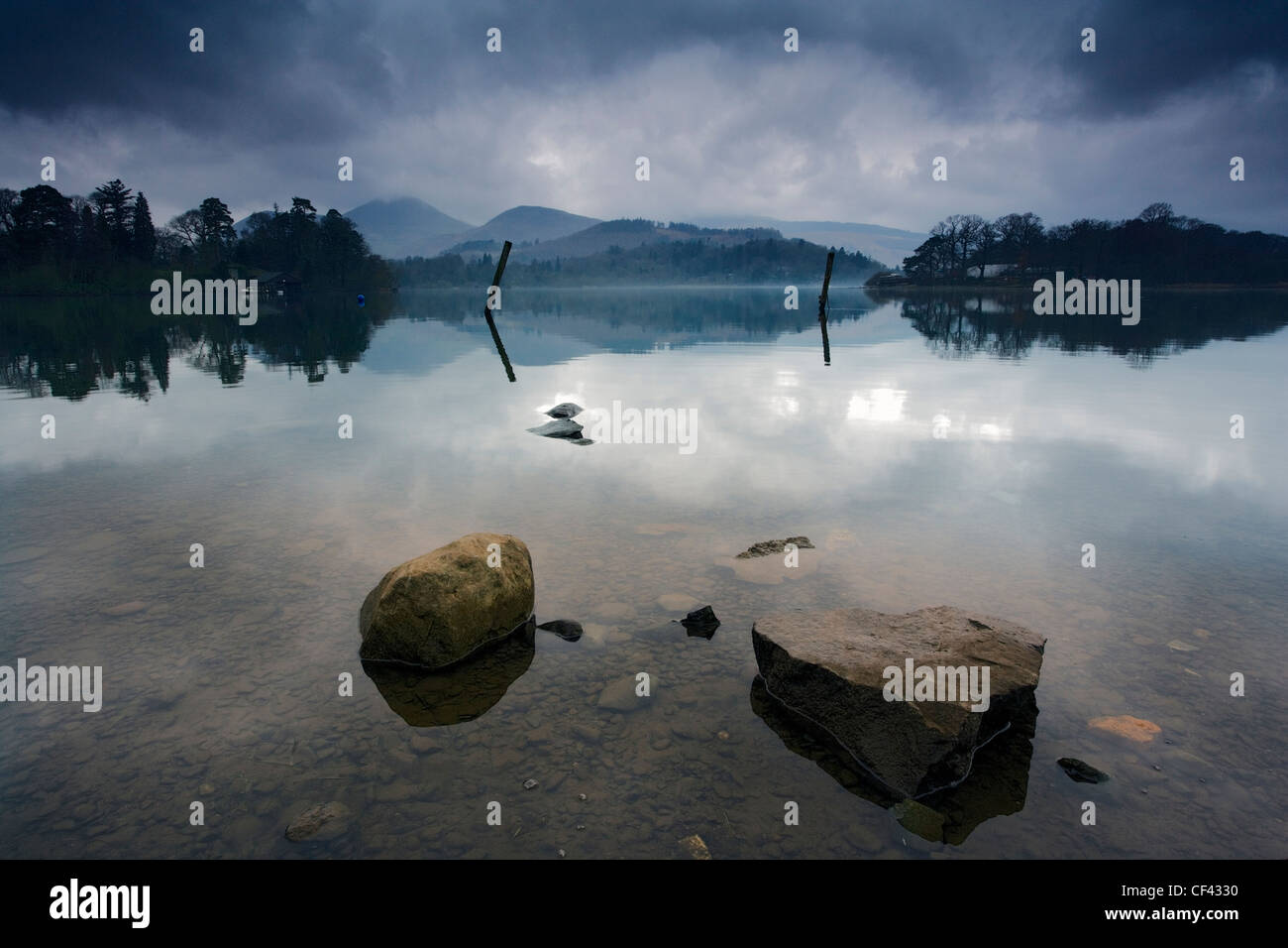 A layer of mist hovers above Lake Derwent as early morning daylight ...