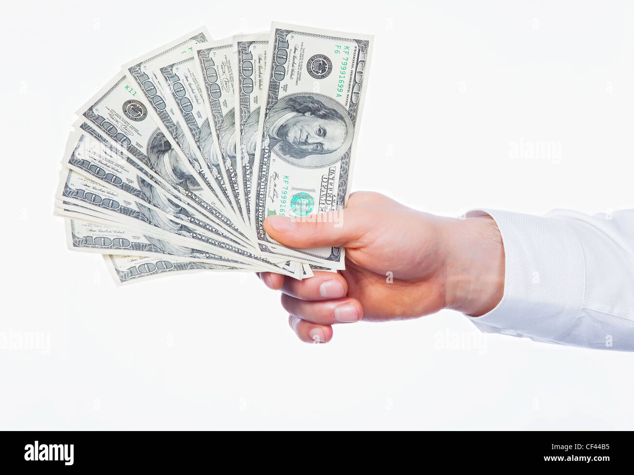 A man's hand holding a handful of dollars Stock Photo - Alamy