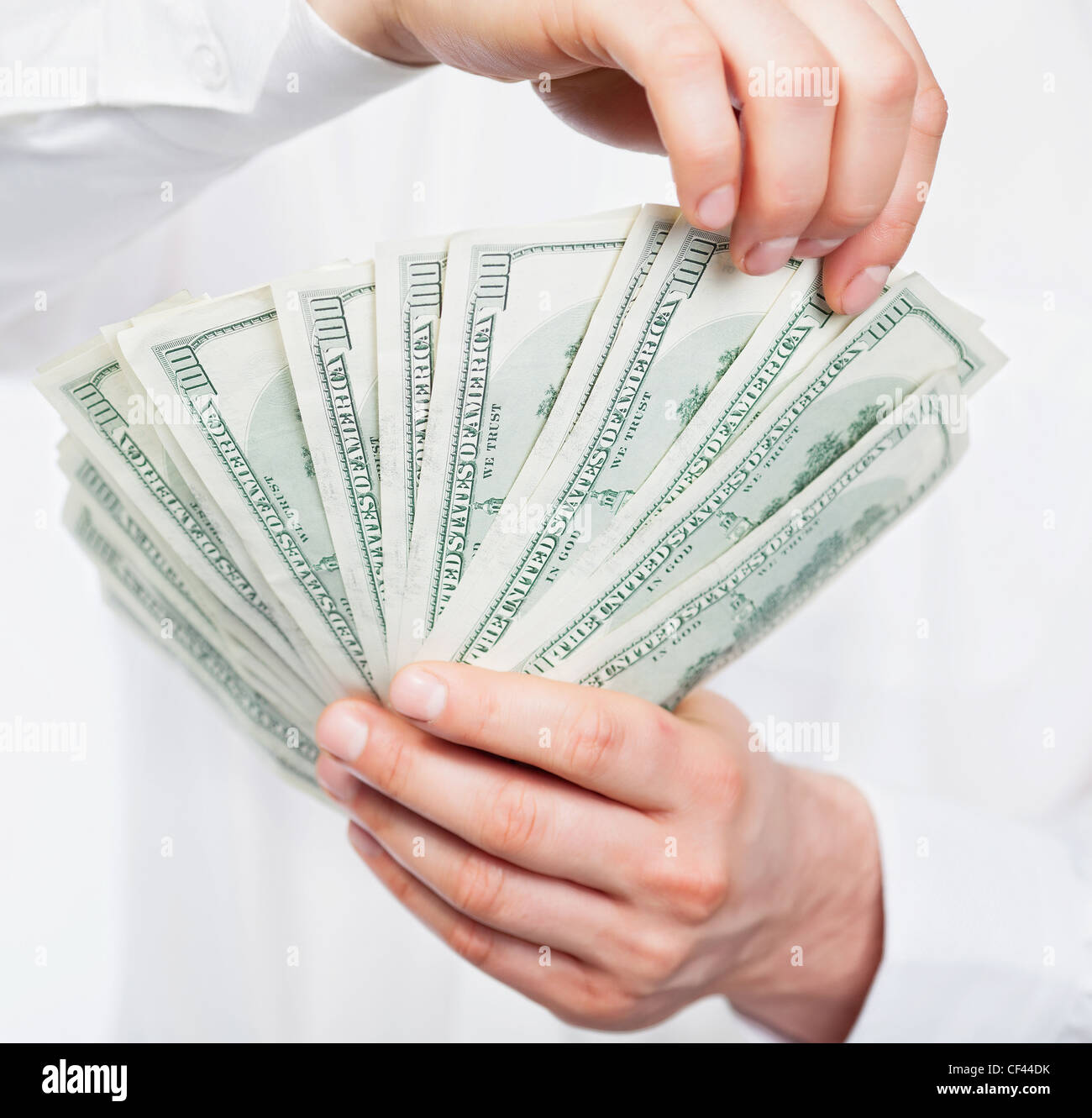 A man's hand holding a handful of dollars Stock Photo - Alamy