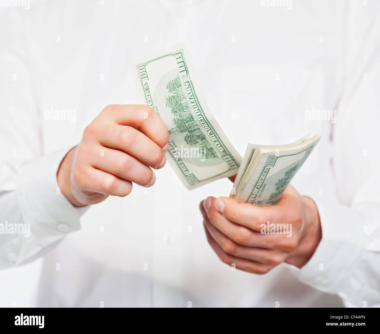 A man counting a handful of dollars Stock Photo - Alamy