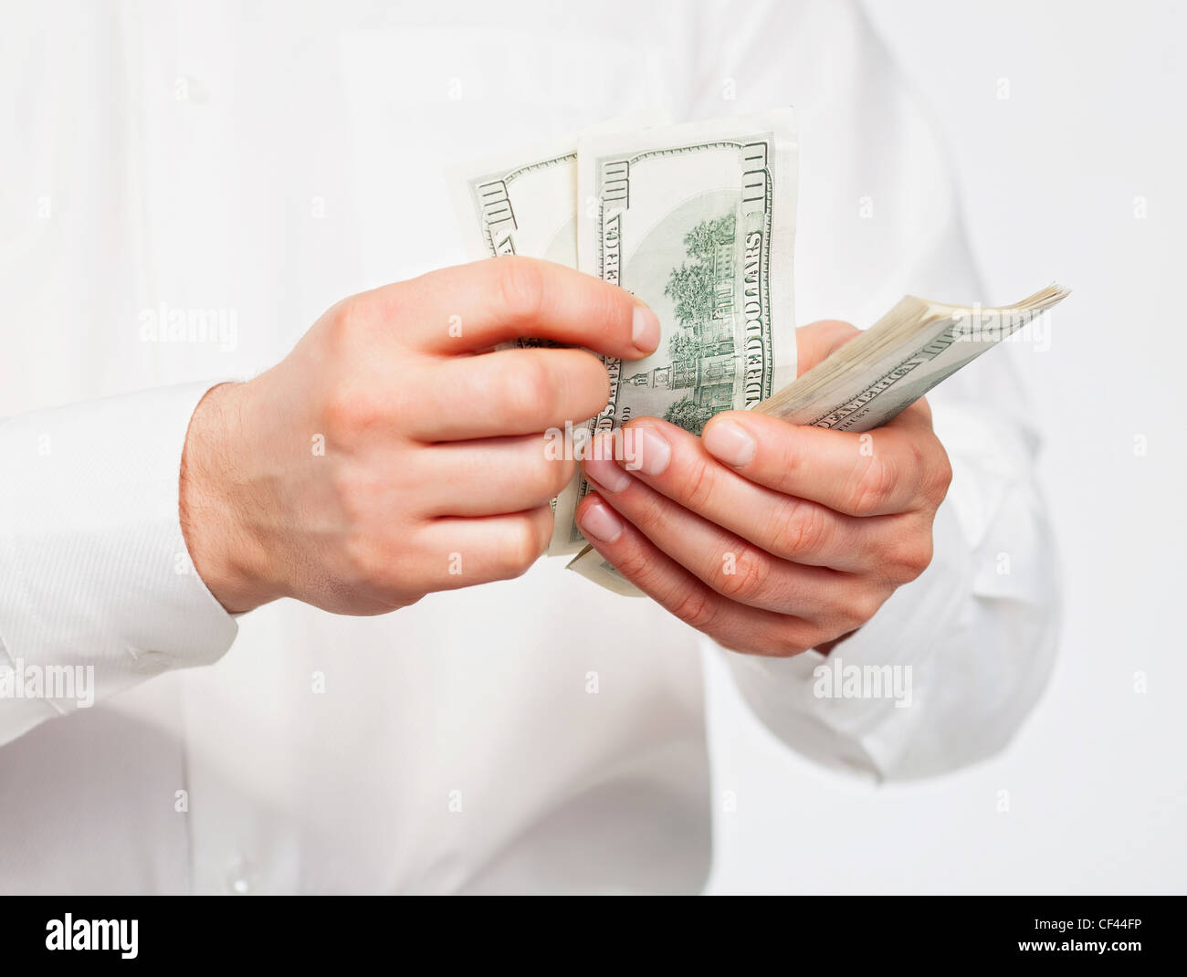 A man counting a handful of dollars Stock Photo - Alamy
