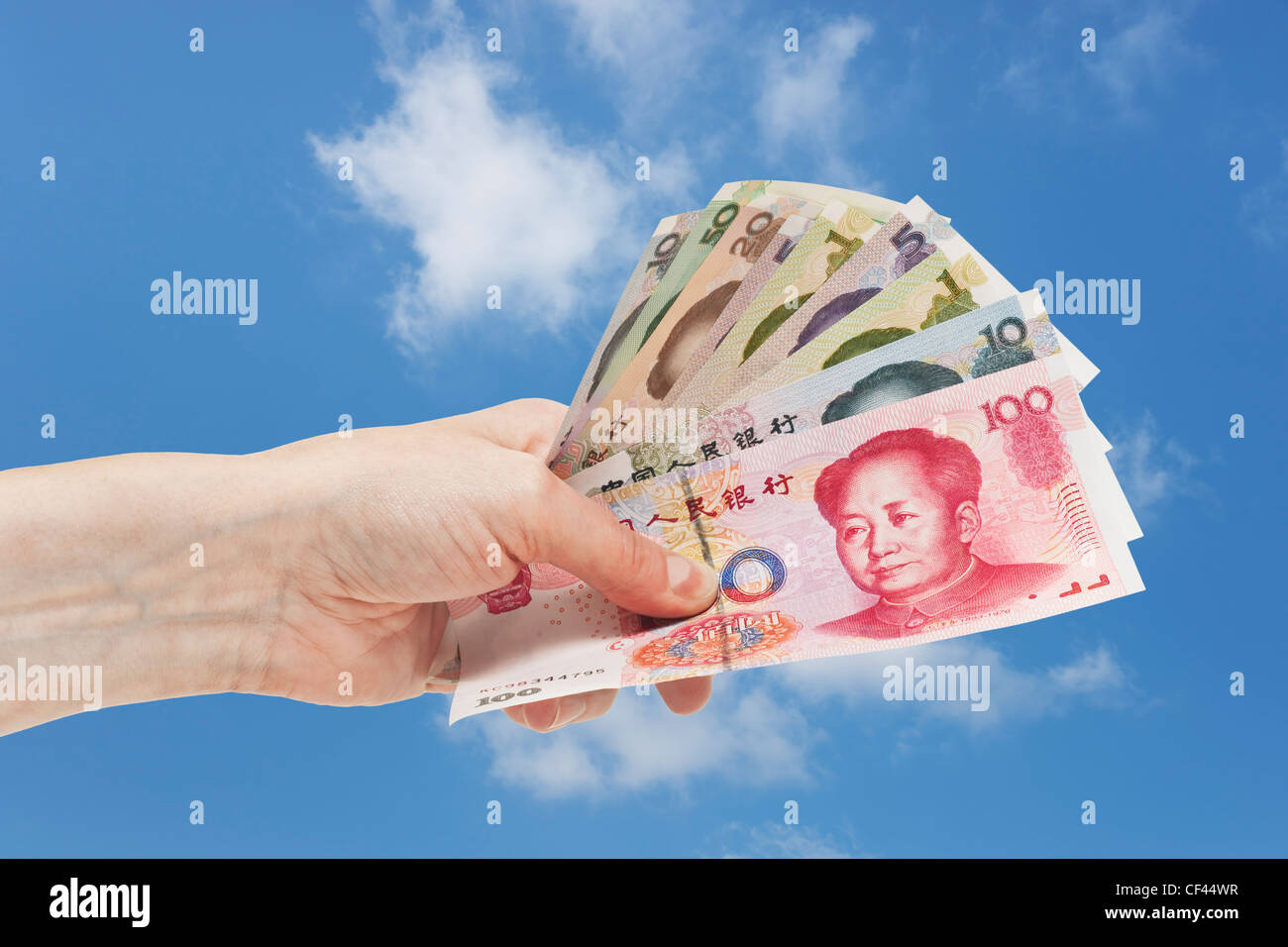 Many diverse Chinese Yuan bills with the portrait of Mao Zedong are ...
