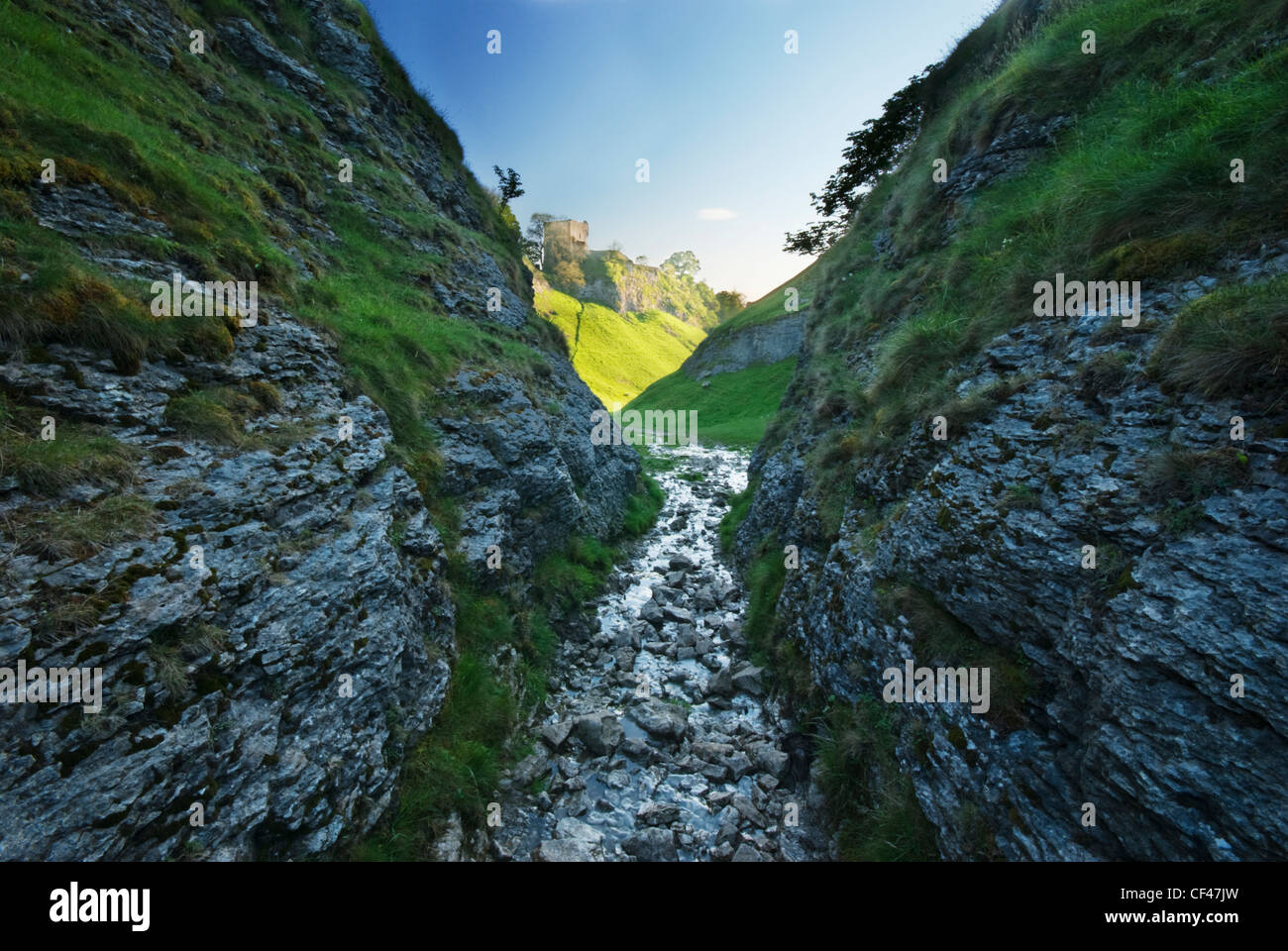 A view of Peveril Castle from a steep rocky gully Stock Photo - Alamy