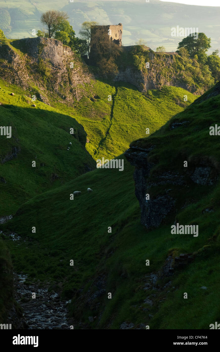 A view of Peveril castle perched on a rocky outcrop in the Peak ...