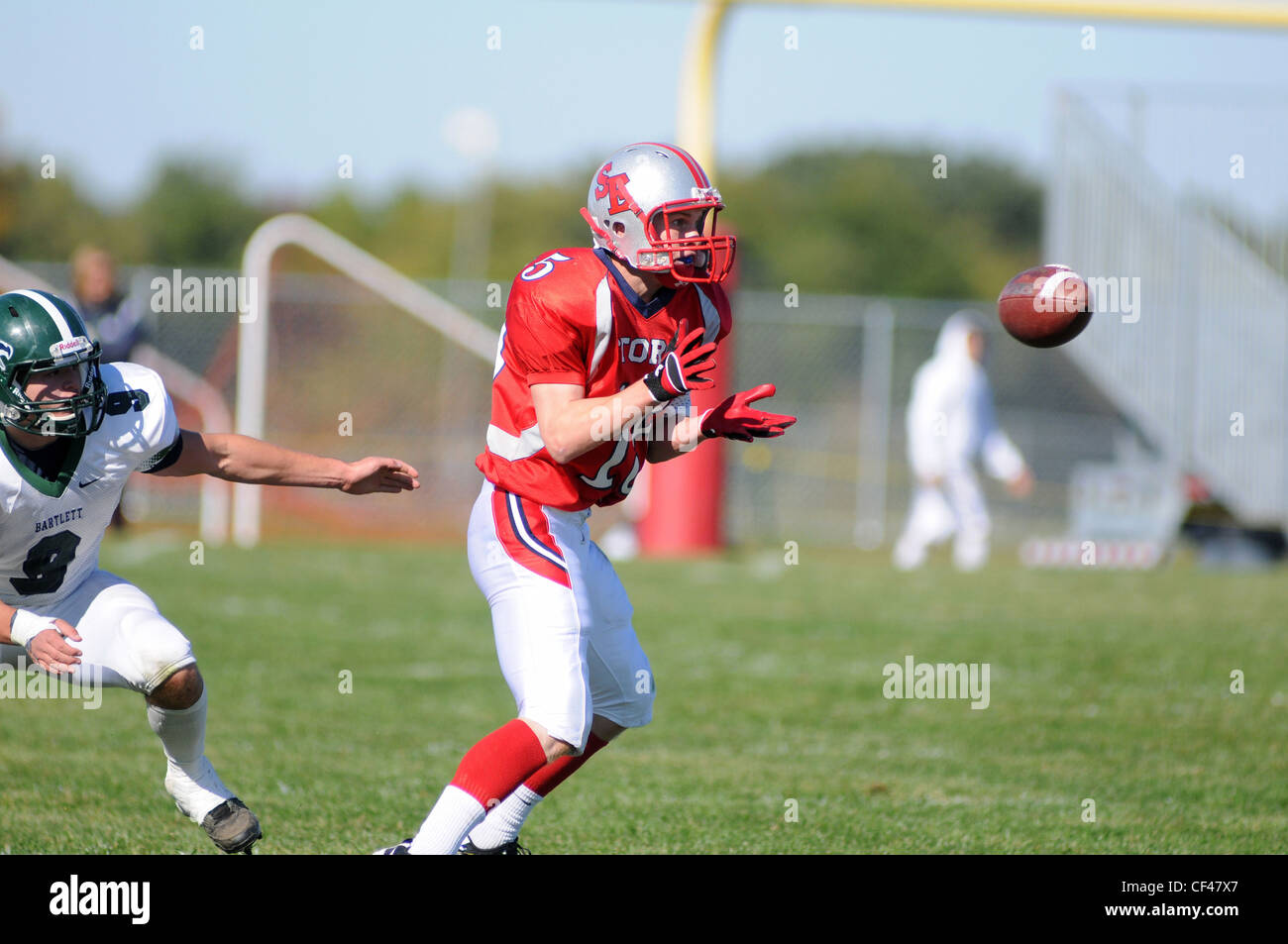 Receiver gains position in front of a defensive back while looking a ...