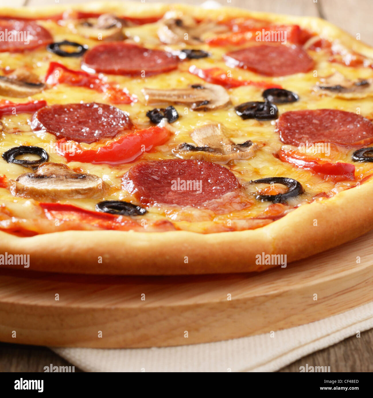 Pepperoni pizza with mushrooms and peppers Stock Photo - Alamy