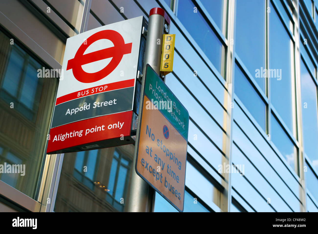 A bus stop sign outside modern office buildings on Appold Street Stock ...