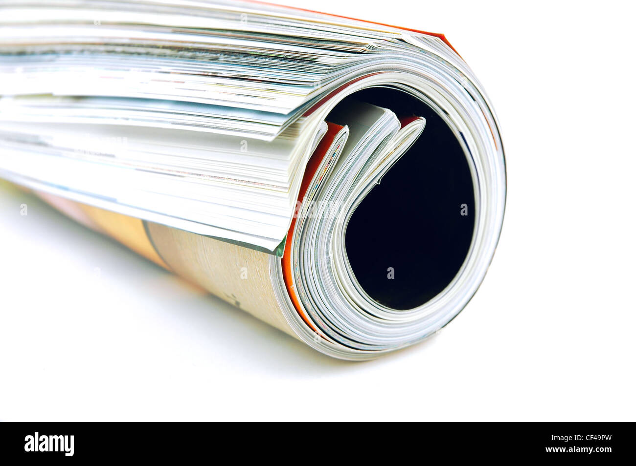 Magazines rolled up on an isolated background Stock Photo - Alamy