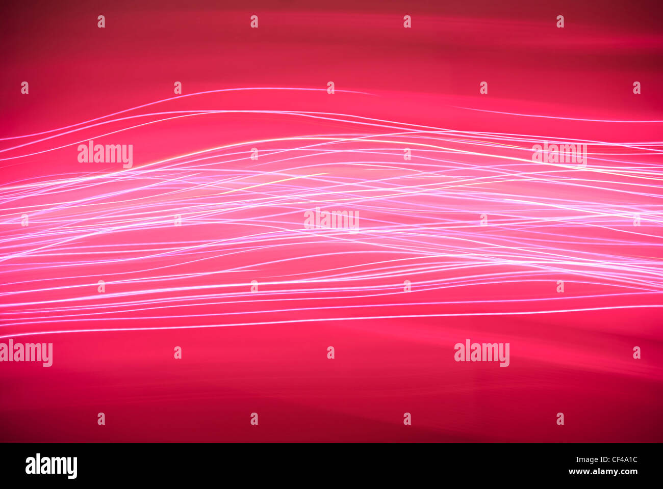 Lines of pink light streaking across a red background Stock Photo - Alamy
