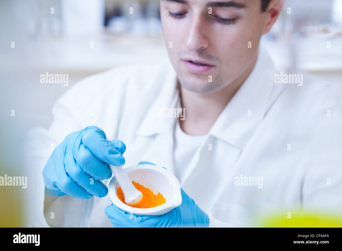 close-up portrait of a young male researcher carrying out experiments ...