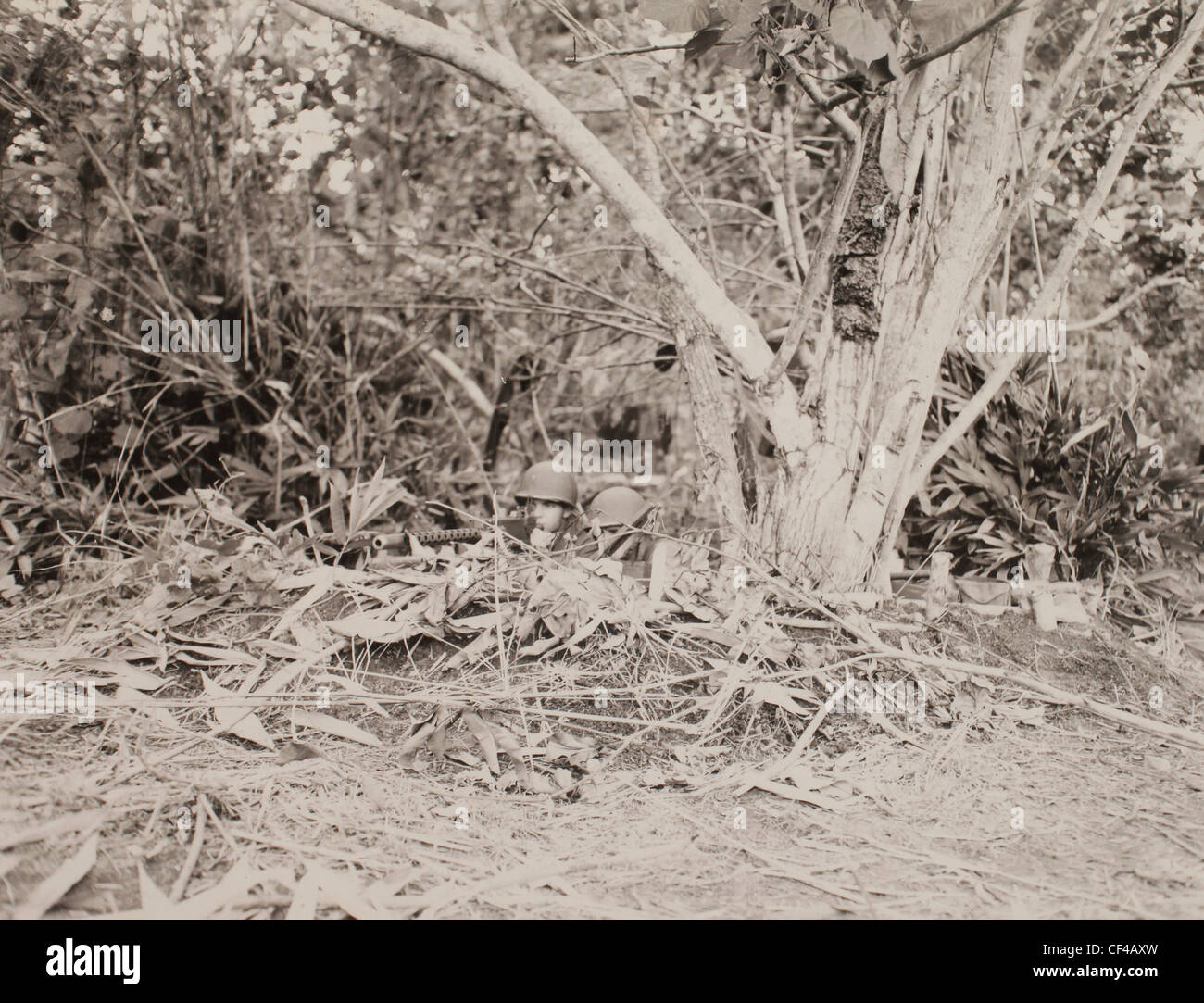 concealed from the enemy two marines man a machine gun in a hastily ...
