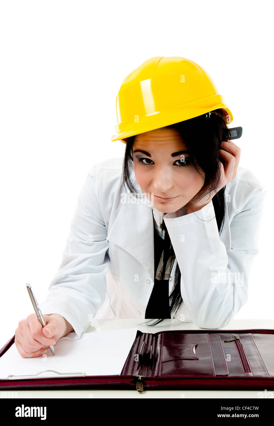 Thinking engineer woman wearing white coat and holding pen Stock Photo ...